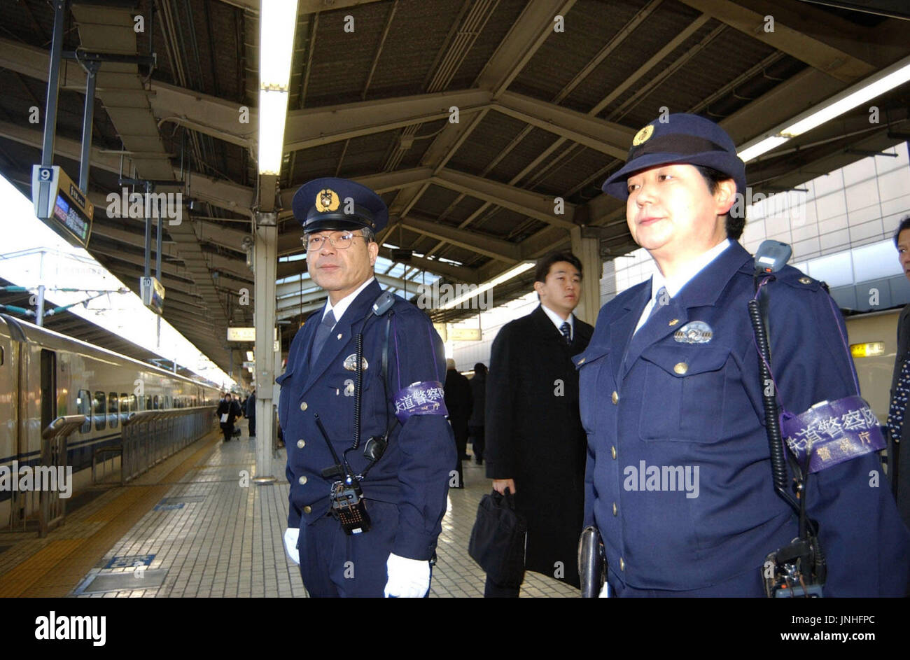 TOKYO, Japan - Police keep watch on a Shinkansen bullet train platform ...