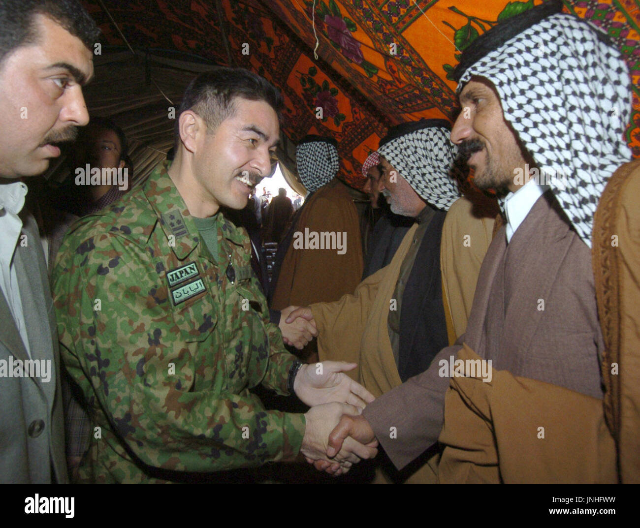 SAMAWAH, Iraq - Col. Masahisa Sato (2nd from L), who heads the advance ...