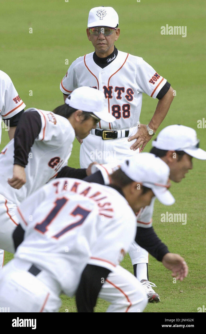 GUAM - Yomiuri Giants new manager Tsuneo Horiuchi watches as his men kick off the 2004 preseason ...