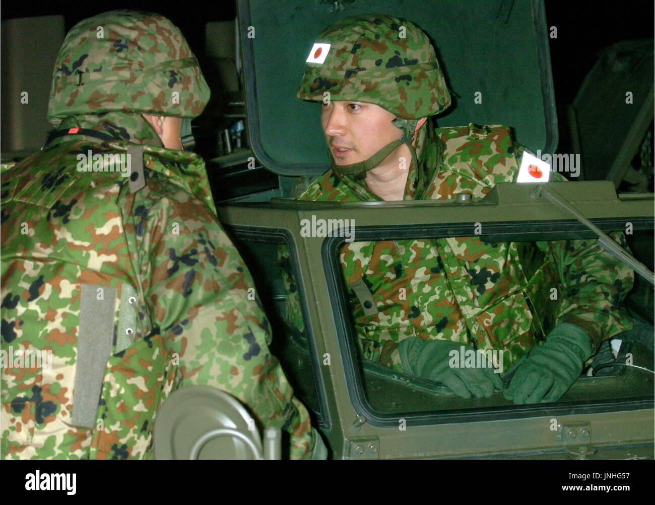 KUWAIT CITY, Kuwait - Two members of Japan's Ground Self-Defense Force (GSDF) core unit talk to ...