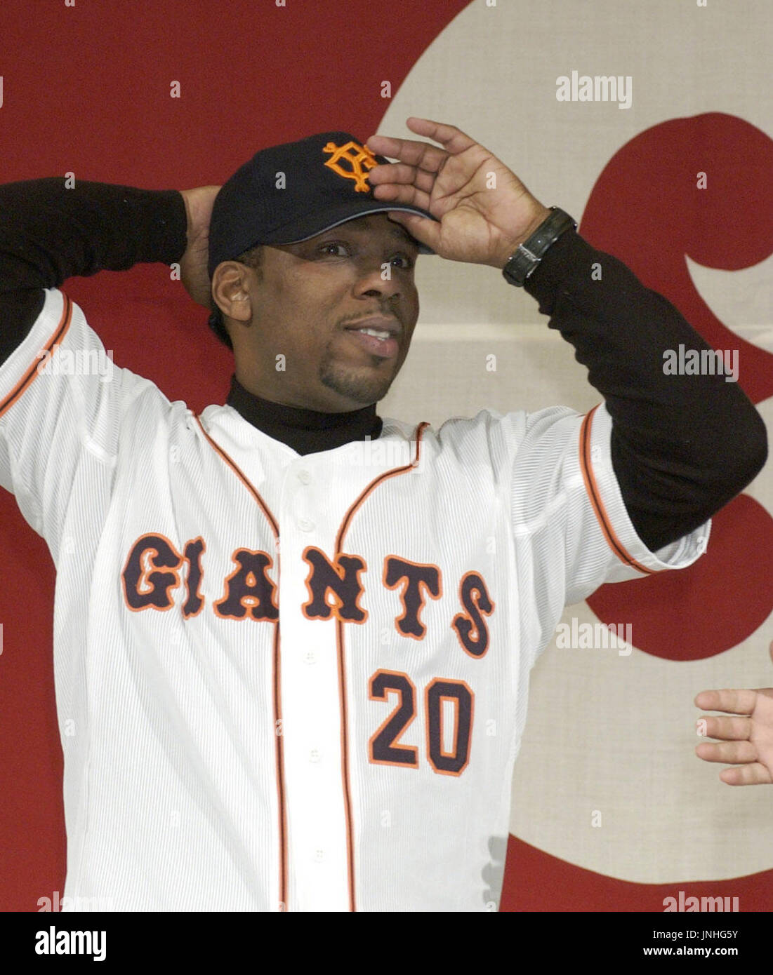 TOKYO, Japan - Tuffy Rhodes puts on his Yomiuri Giants uniform for the ...