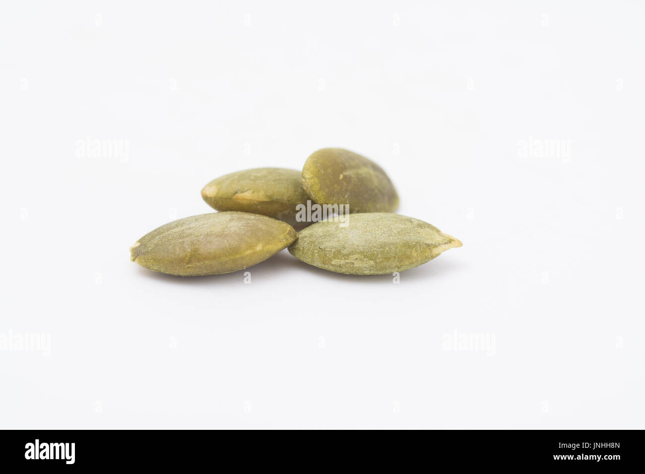 Roasted pumpkin kernels isolated on white background Stock Photo - Alamy