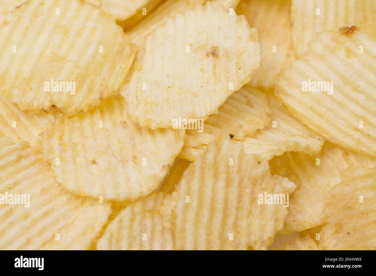 Potato chips background Stock Photo - Alamy
