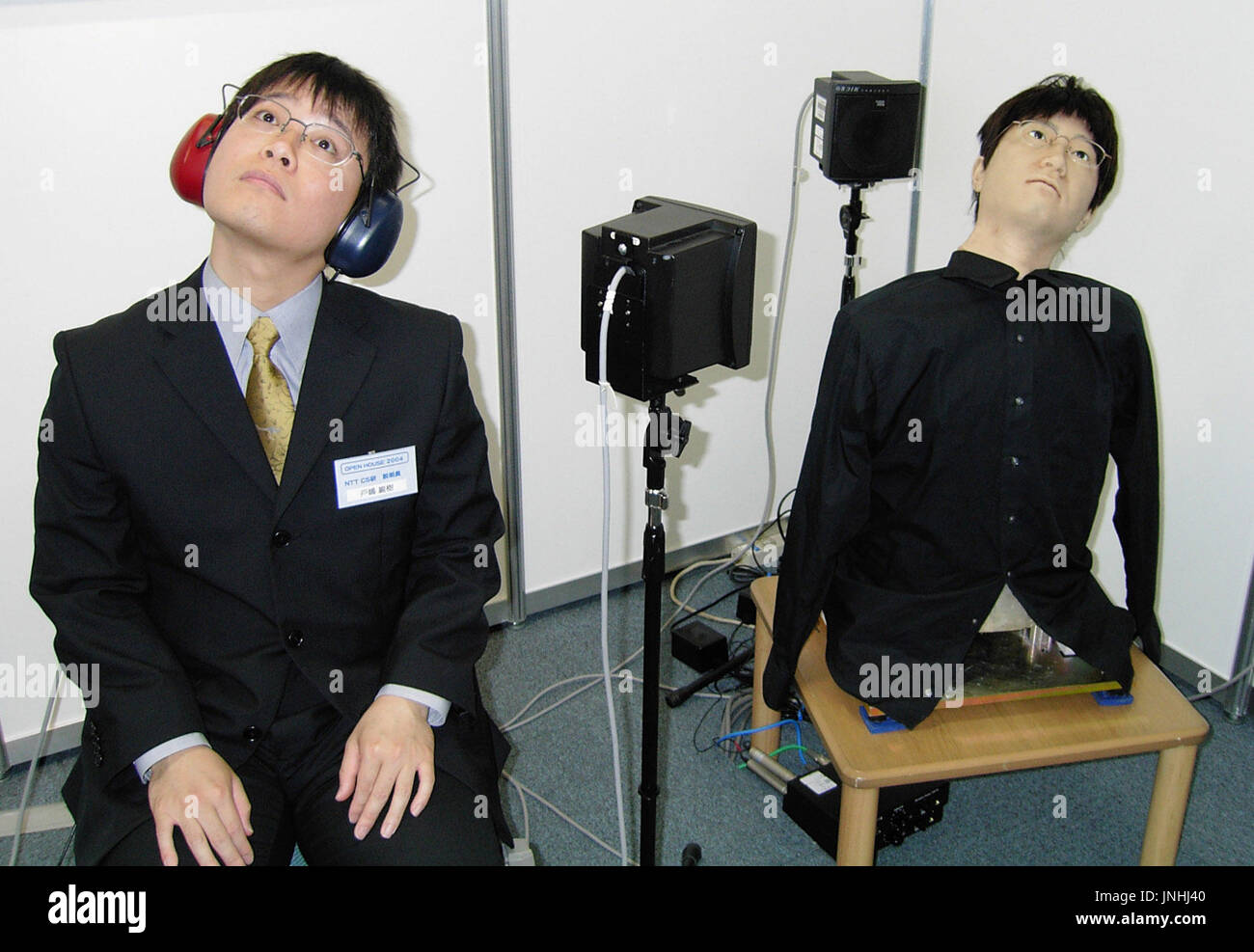 OSAKA, Japan - A robot (R), developed by NTT Communication Science ...