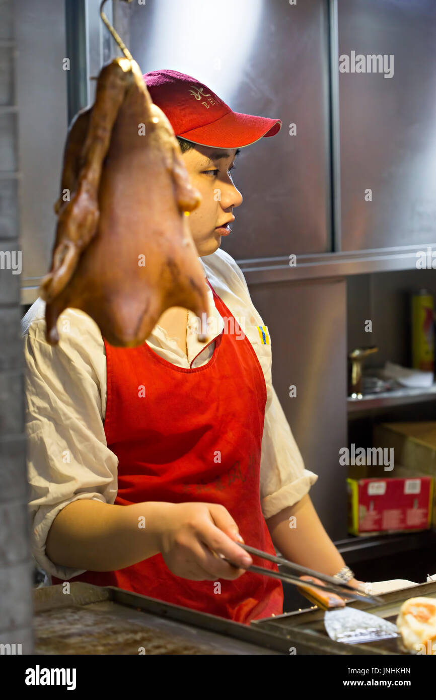 Chinese salesman in red on food stall, Chinese traditional food market ...
