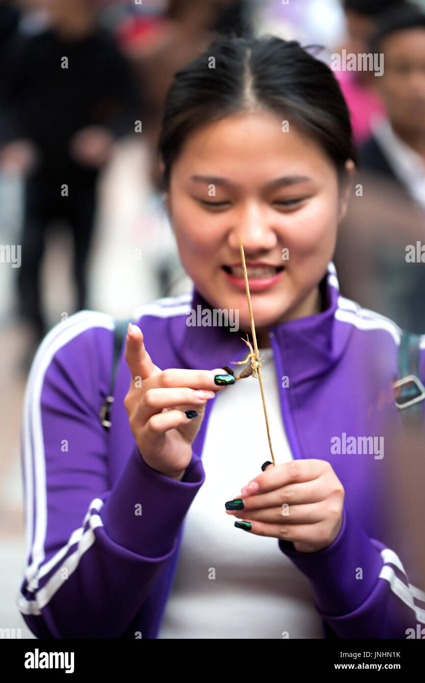 Chinese girl in sport gear on Wangfujing Market, Beijing, China trying ...