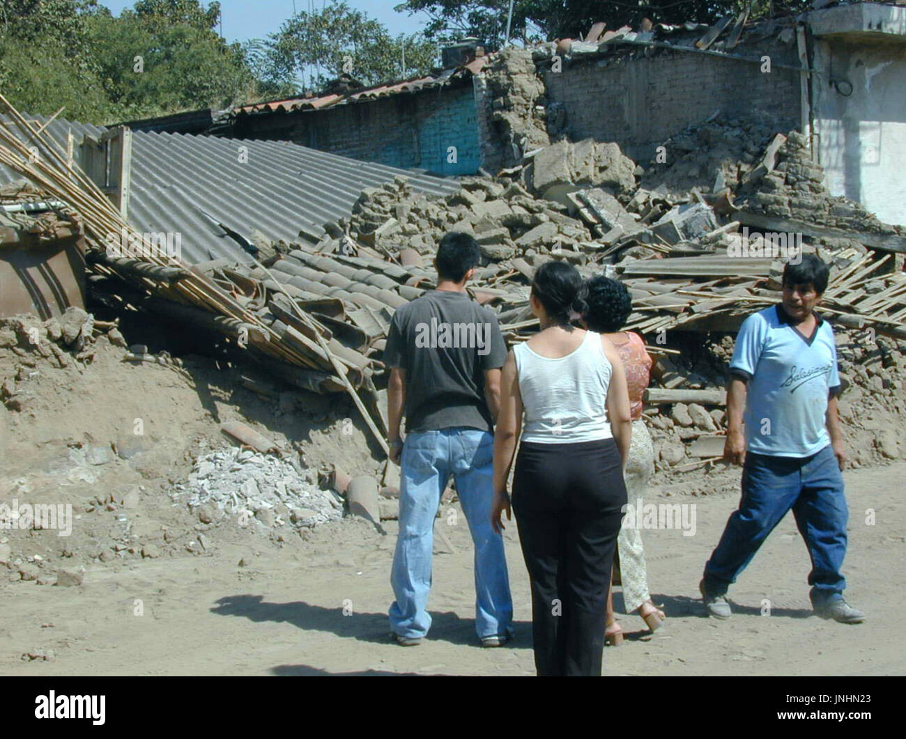 COLIMA, Mexico - People look at a house Jan. 23 in the Mexican state of ...