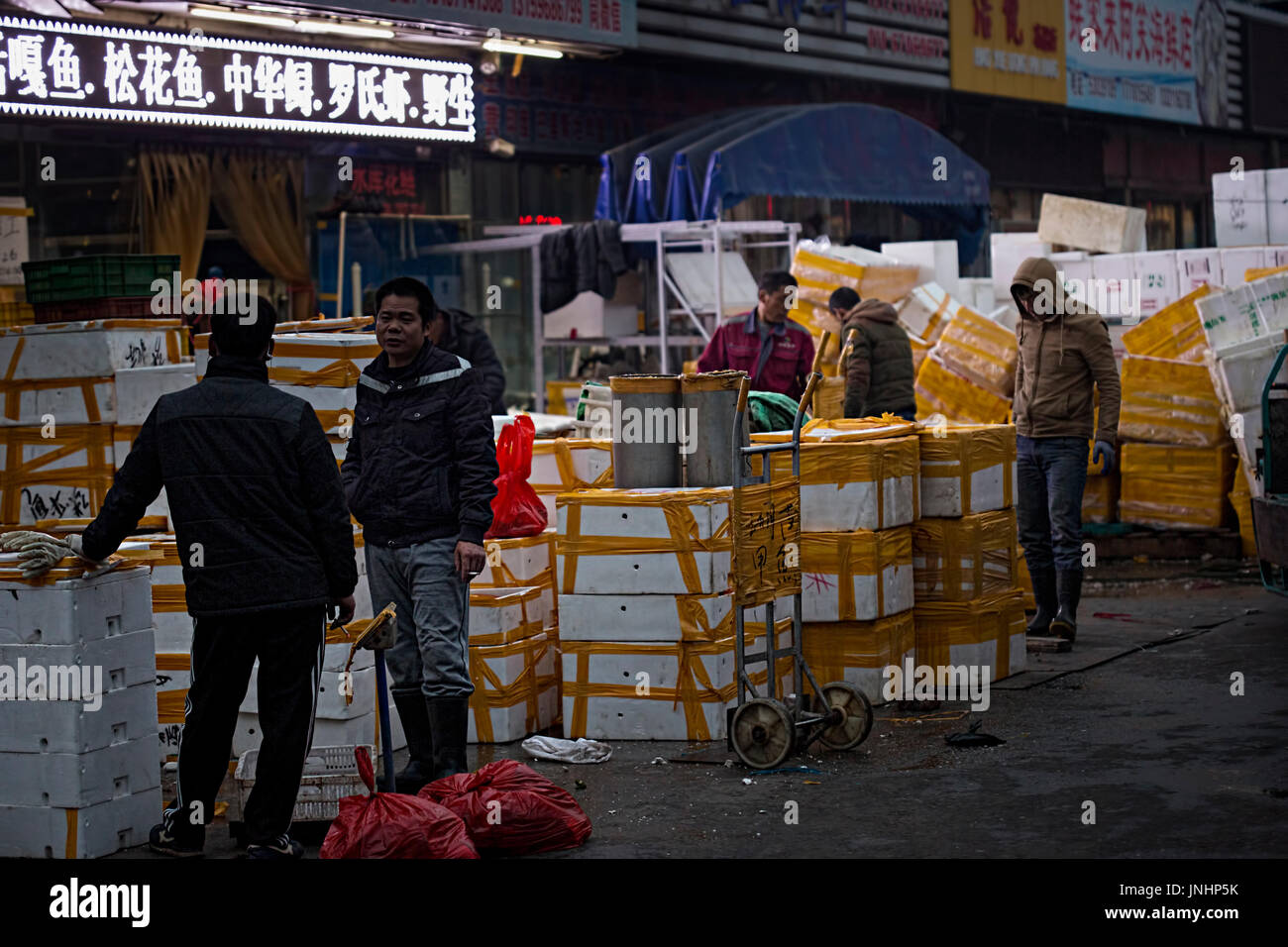 JingShen Seafood Market in the evening. Workers packing products after ...