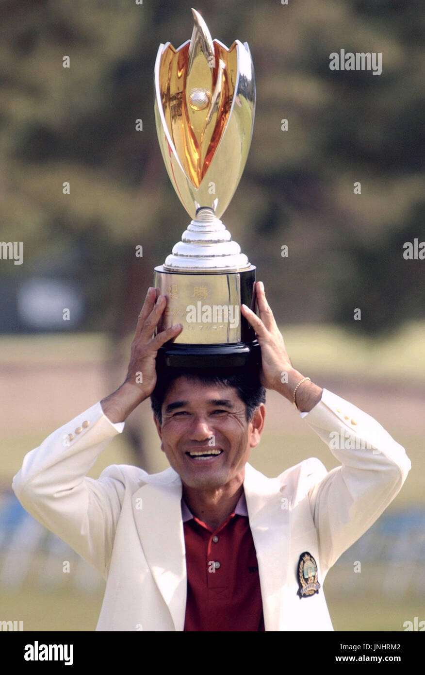 SHIBATA, Japan - Katsuyoshi Tomori puts his trophy on the head in joy ...