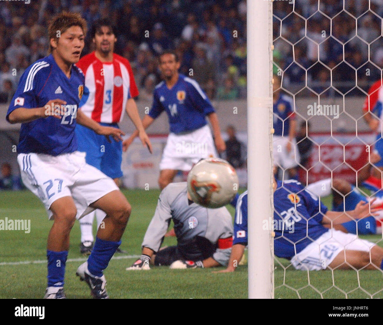 SAITAMA, Japan - Midfielder Alessandro Santos (background) watches as ...