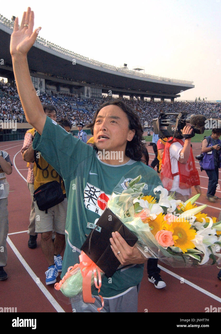 TOKYO, Japan - Former Japan midfielder Tsuyoshi Kitazawa waves to fans ...