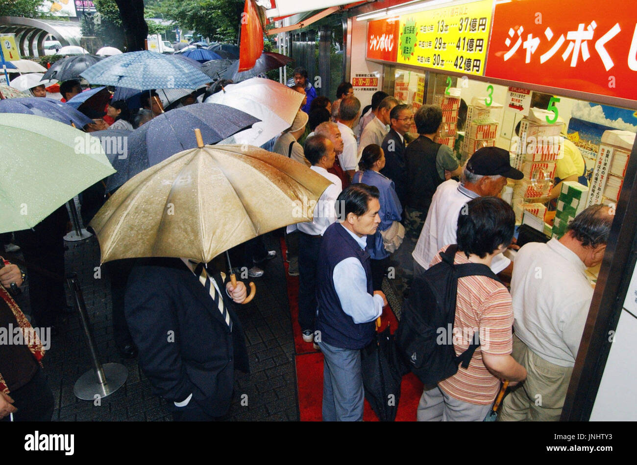 TOKYO, Japan - Despite the rain, Japanese line up at lottery booths in ...