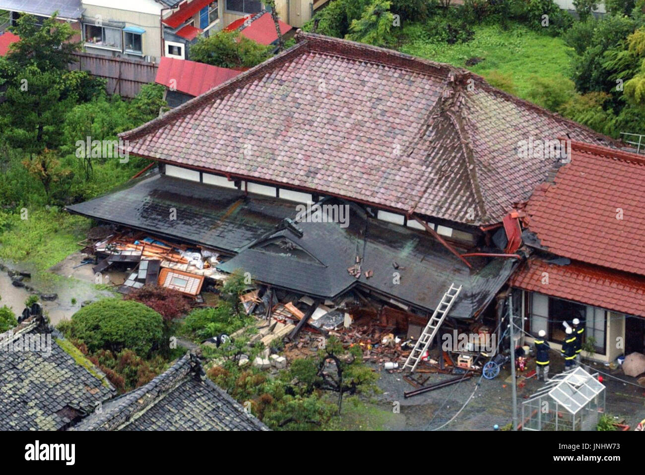 SENDAI, Japan - The first floor of a house is seen crushed in the town ...