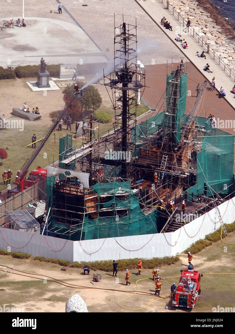 KOBE, Japan - Firefighters fight to put out a fire aboard a replica of ...