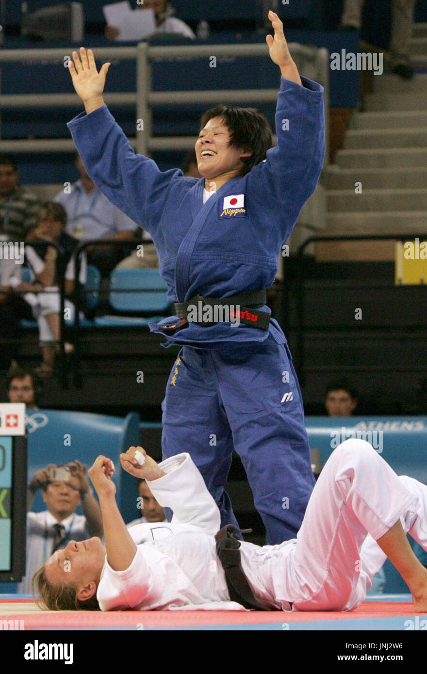 ATHENS, Greece - Ayumi Tanimoto (standing) rejoices after grabbing Japan's fourth judo gold by ...