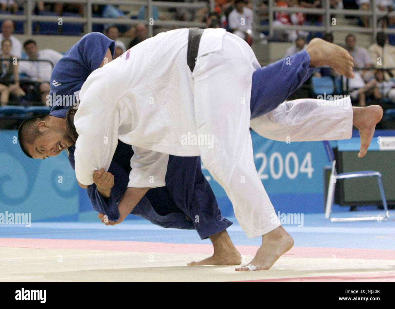 ATHENS, Greece - Keiji Suzuki of Japan defeats Yury Rybak of Belarus with a uchimata ippon to ...