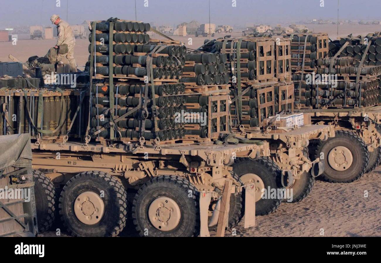 KUWAIT - Transport vehicles laden with ammunition stand ready for a ...