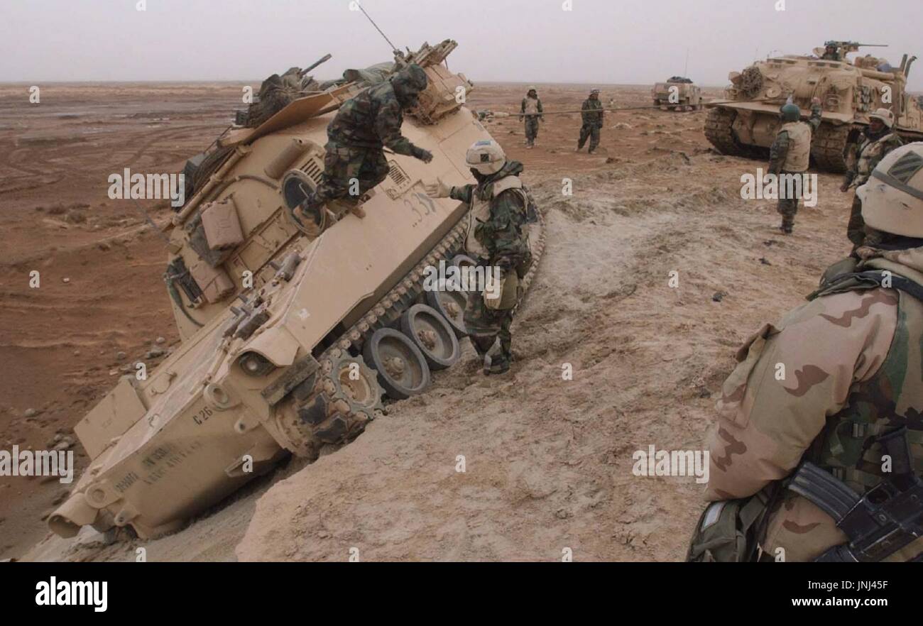 SAMAWAH, Iraq - Two U.S. soldiers check an armored vehicle stuck in the ...