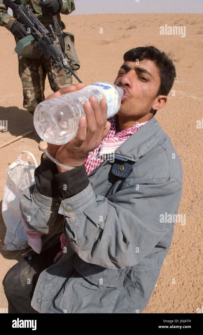 SAMAWAH, Iraq - An Iraqi man drinks water after surrendering to the U.S ...
