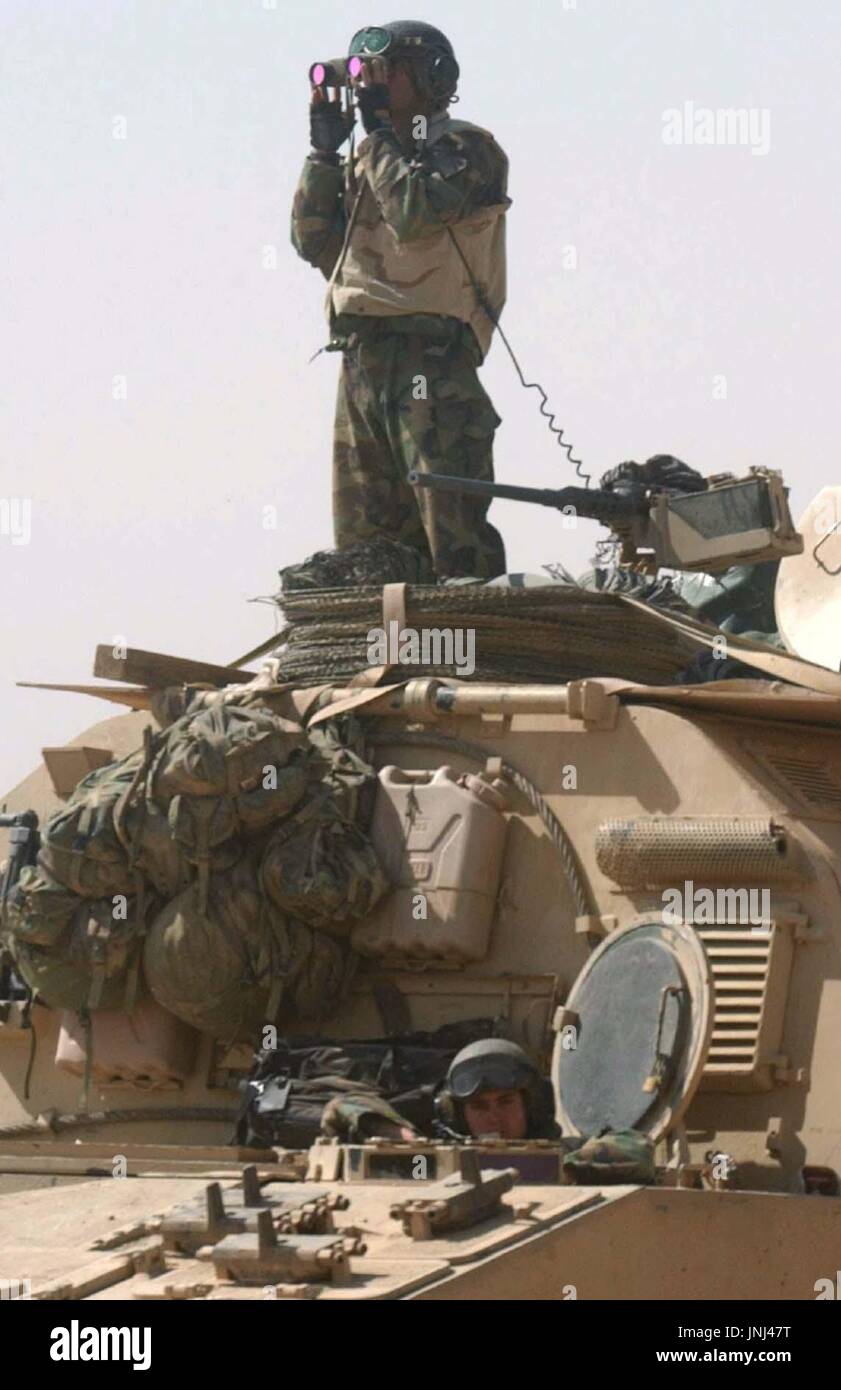 SAMAWAH, Iraq - A U.S. soldier keeps watch aboard his armored vehicle ...