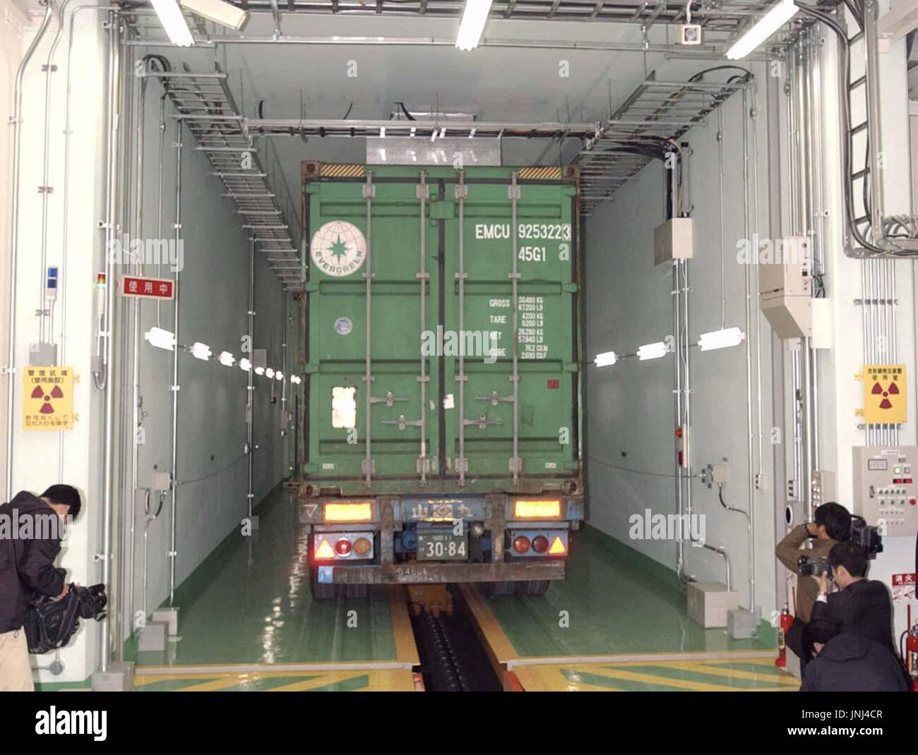 FUKUOKA, Japan - Containers are pulled through a 94-meter-long X-ray ...
