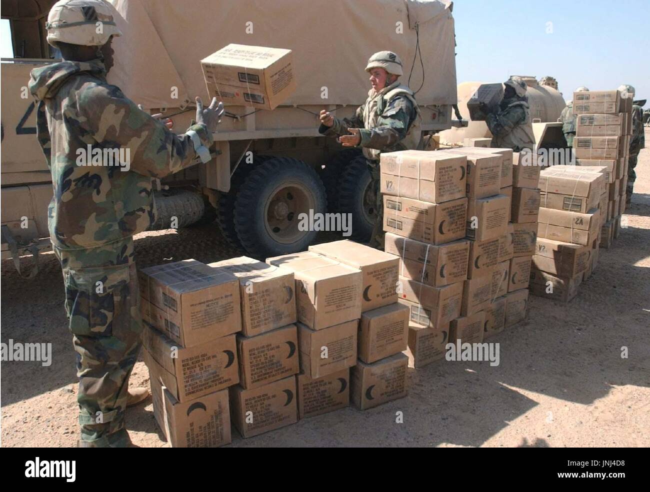 KARBALA, Iraq - Two U.S. 3rd Infantry Division soldiers sort out boxes ...
