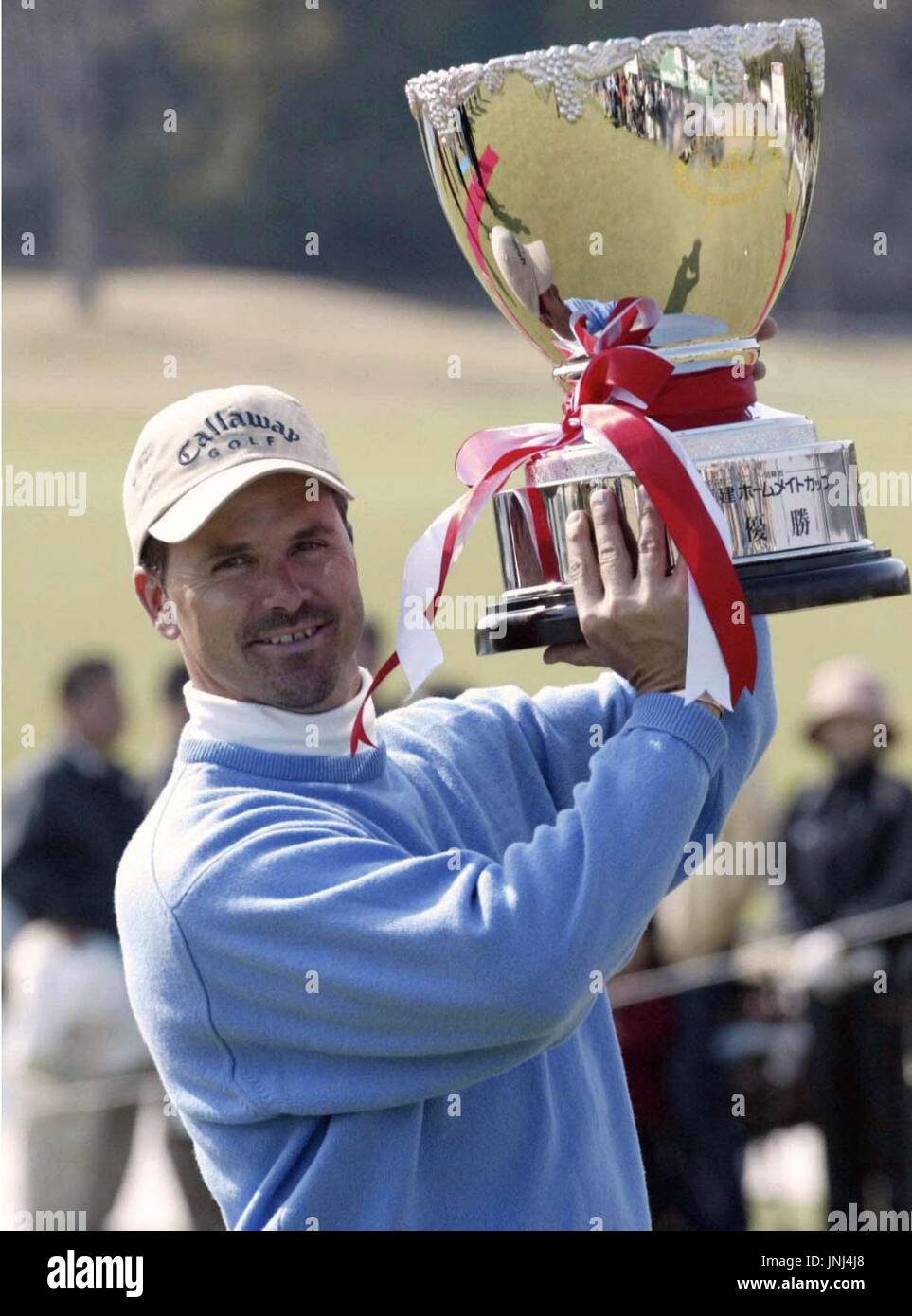 TADO, Japan - Andre Stolz of Australia raises a trophy after capturing ...