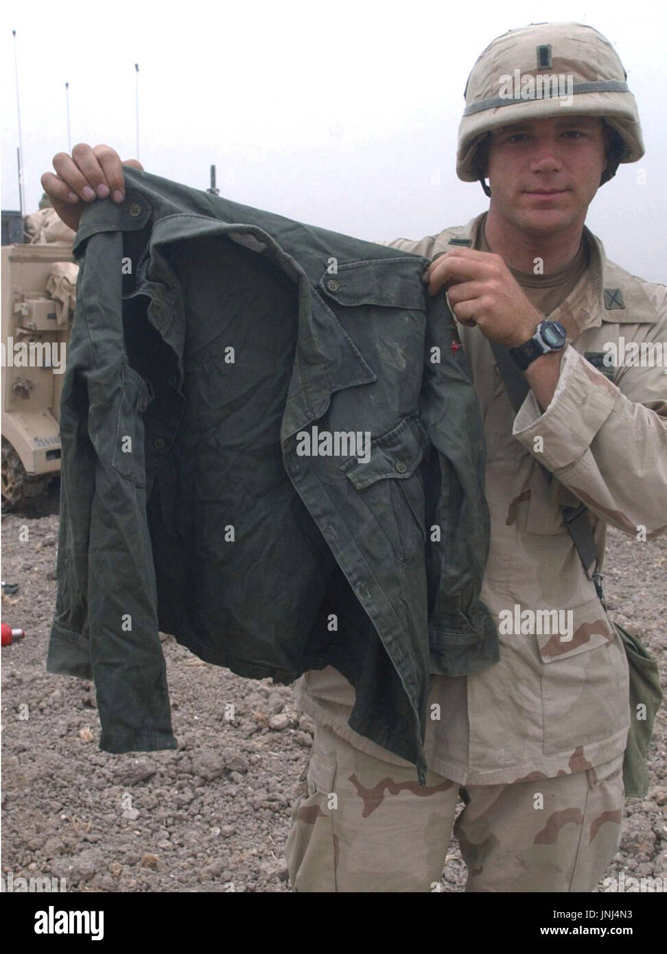 BAGHDAD, Iraq - A U.S. soldier holds up a jacket, believed to be a ...