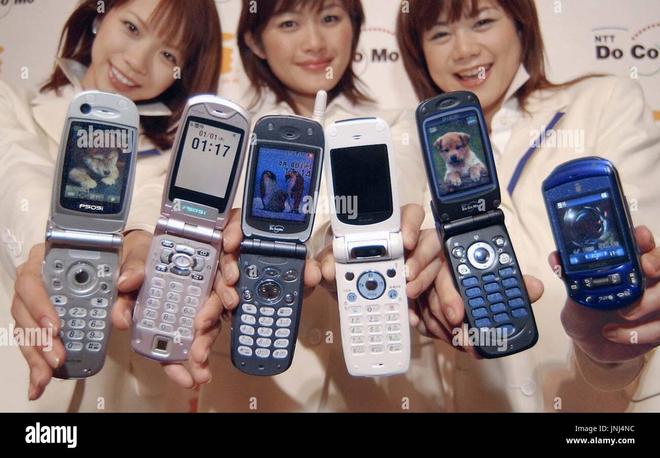 TOKYO, Japan - Women hold up NTT DoCoMo Inc.'s new Internet-capable ...