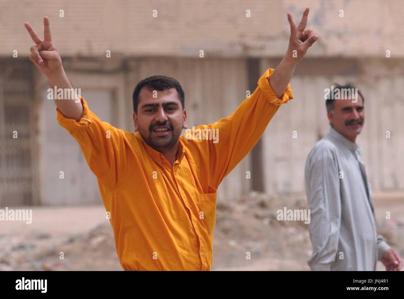 BAGHDAD, Iraq - An Iraqi man makes victory signs in Saddam City on ...