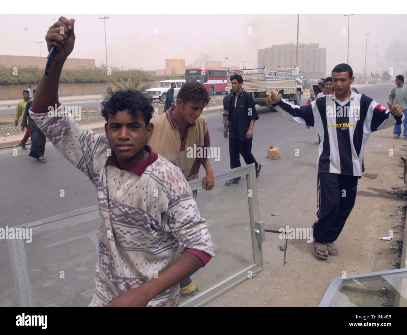 BAGHDAD, Iraq - People in Saddam City celebrate by looting as the ...