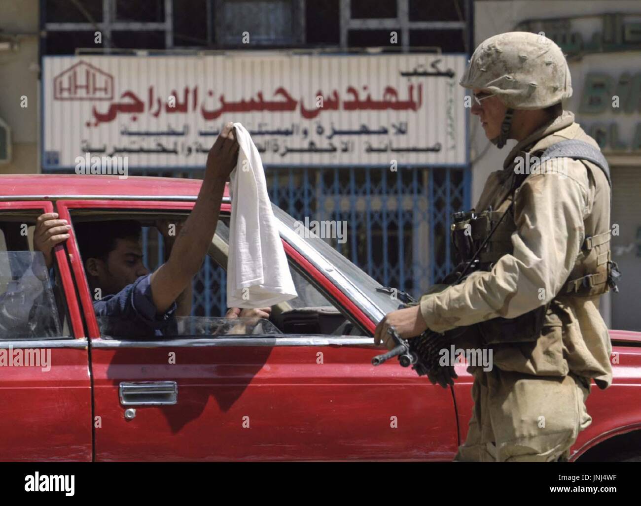BAGHDAD, Iraq - An Iraqi man shows a white flag to a U.S. soldier ...