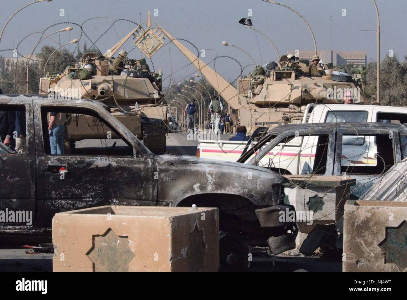 BAGHDAD, Iraq - Tanks and burnt-out vehicles block a bridge over the ...