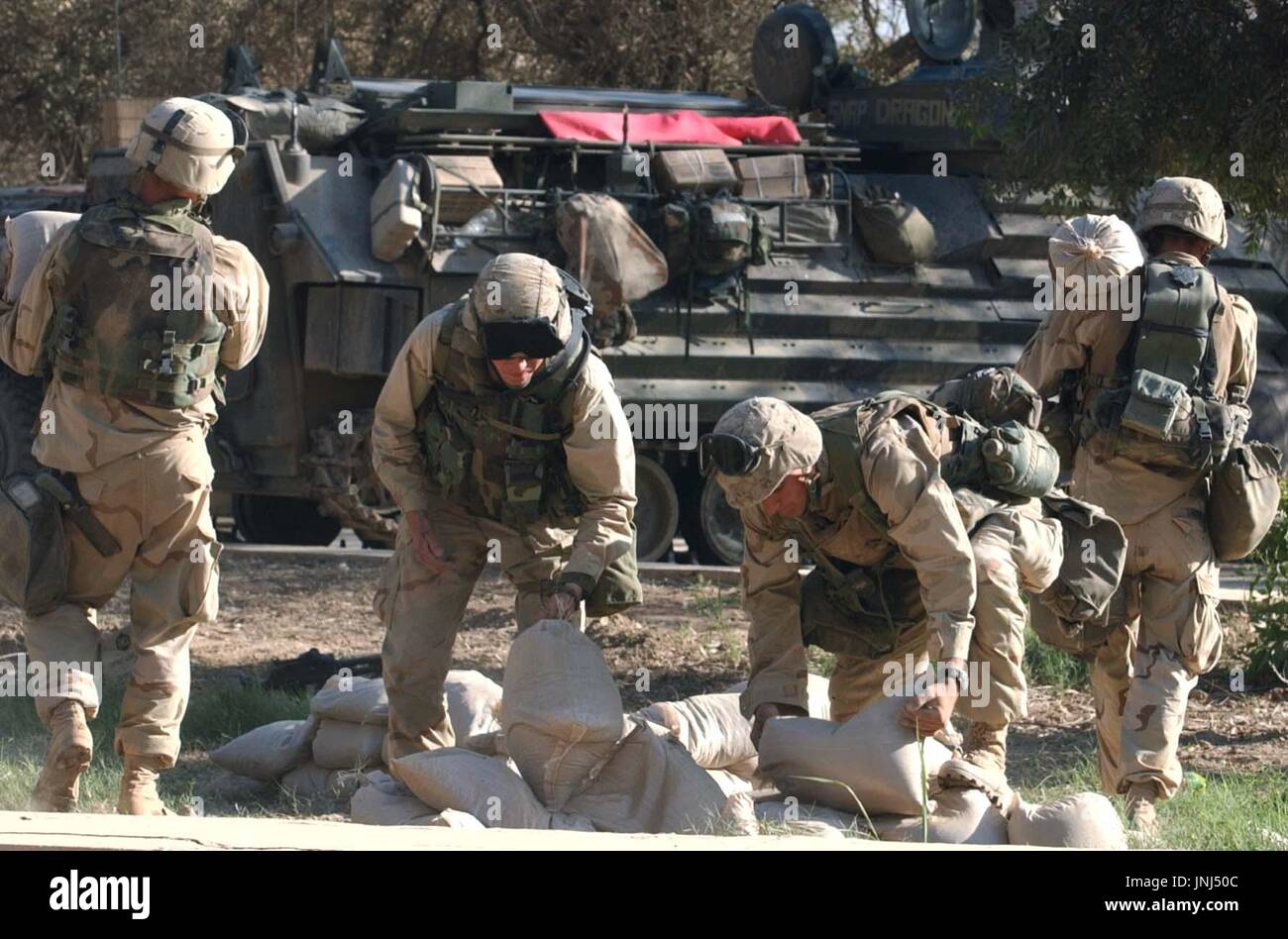 BAGHDAD, Iraq - U.S. soldiers make and carry sandbags in Baghdad on ...