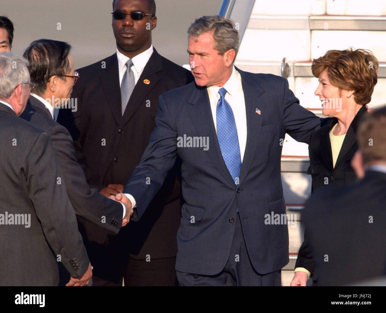 TOKYO, Japan - U.S. President George W. Bush (C) shakes hands with ...