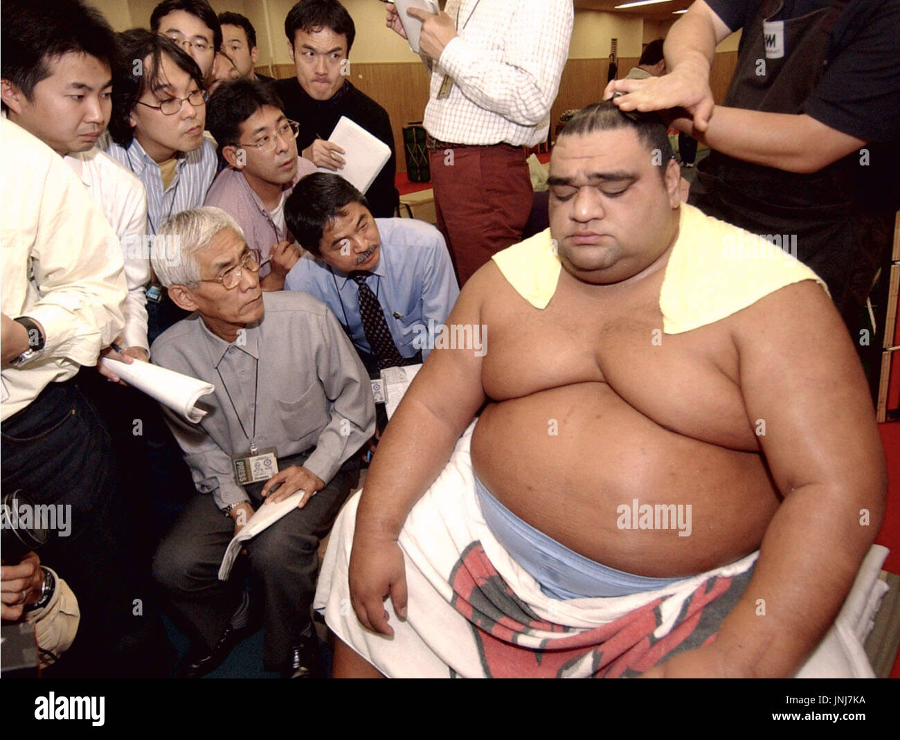 TOKYO, Japan - Reporters swarm around Yokozuna Musashimaru after he ...