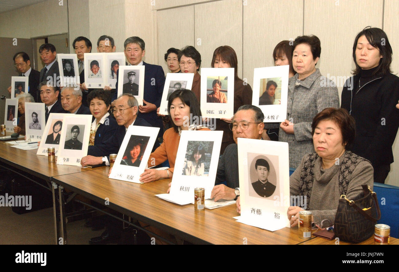 TOKYO, Japan - Family members hold photos of their 16 missing relatives ...