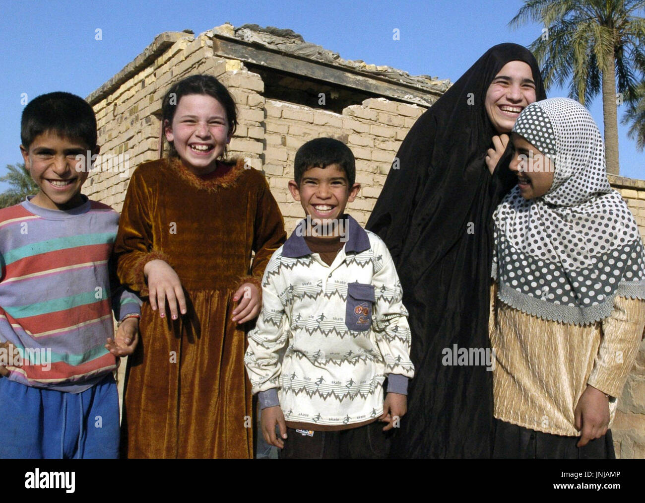 SAMAWAH, Iraq - Children smile for photographers in the southern Iraqi ...