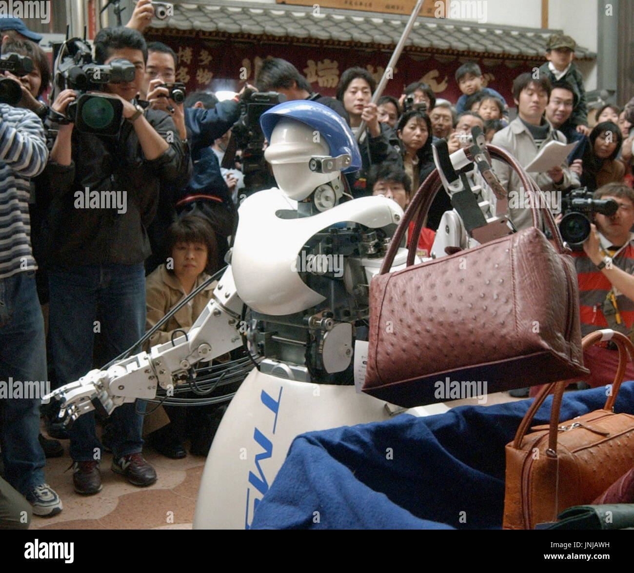 FUKUOKA, Japan - A humanoid robot picks up a handbag at a shop in ...