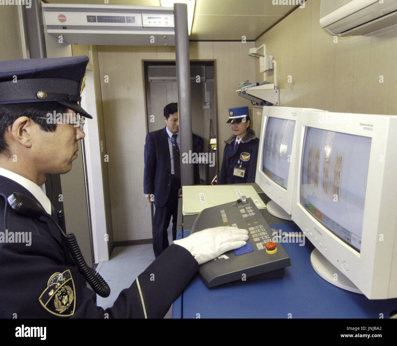 TOKYO, Japan - A guard inspects a security system installed at the ...