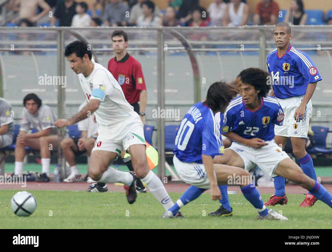 CHONGQING, China - Iranian skipper Ali Daei (L) takes the ball from ...