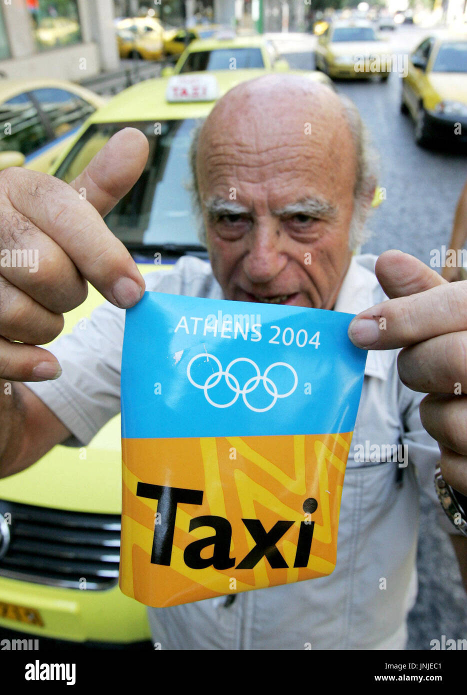 ATHENS, Greek - A taxi driver shows off an Olympic sticker to be put to ...