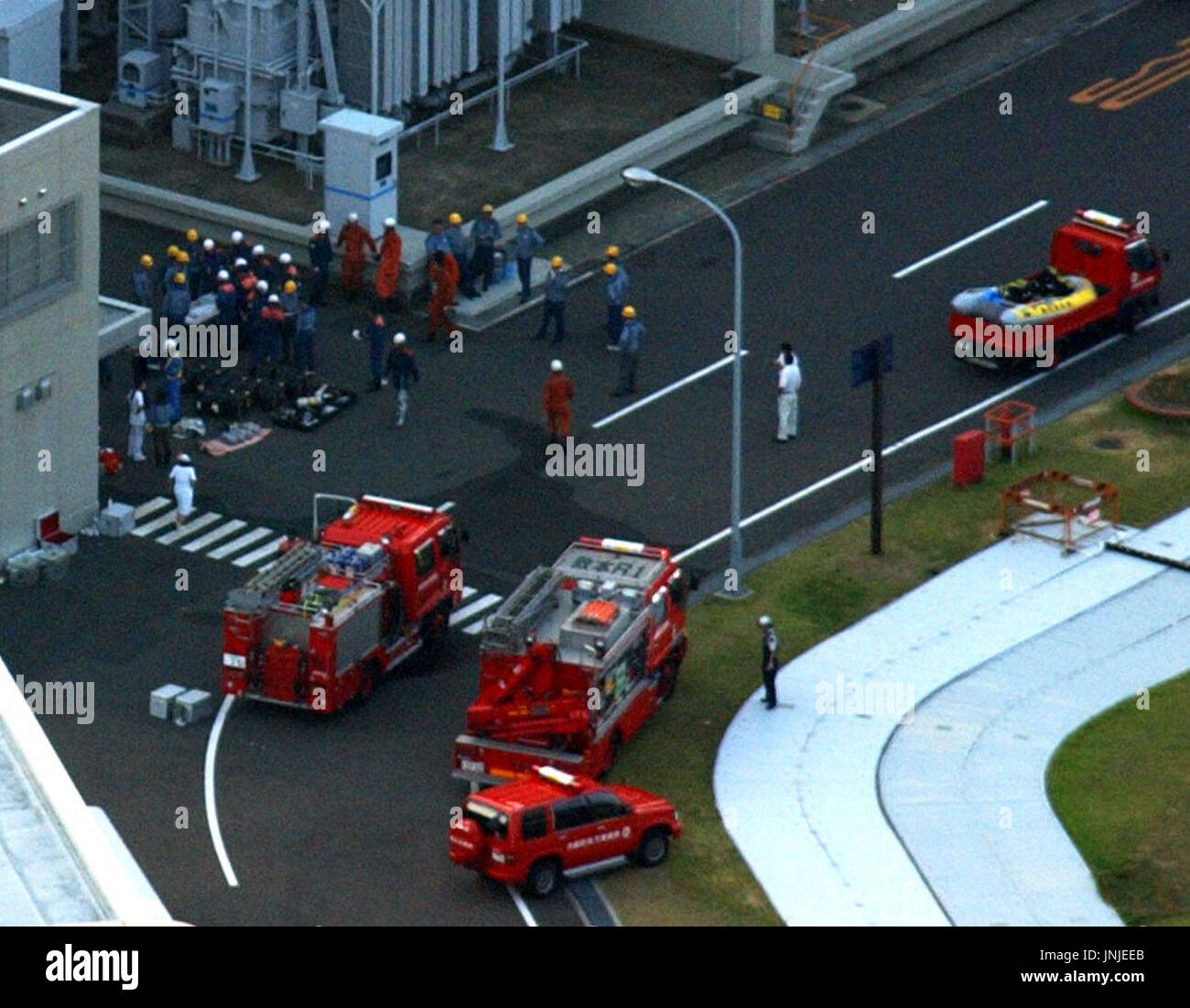 OSAKA, Japan - Firefighters gather in front of the No. 3 reactor of ...