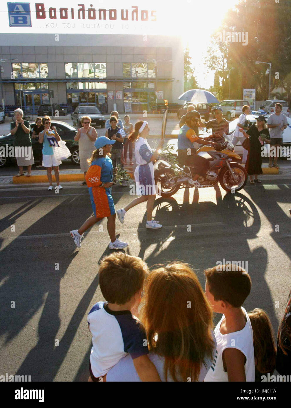 MARATHON, Greece - A torch relay runner runs through the city of ...