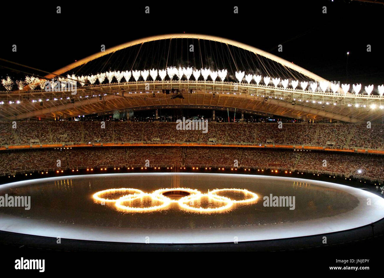 ATHENS, Greece - The Olympic rings are lit up as fireworks explode at ...