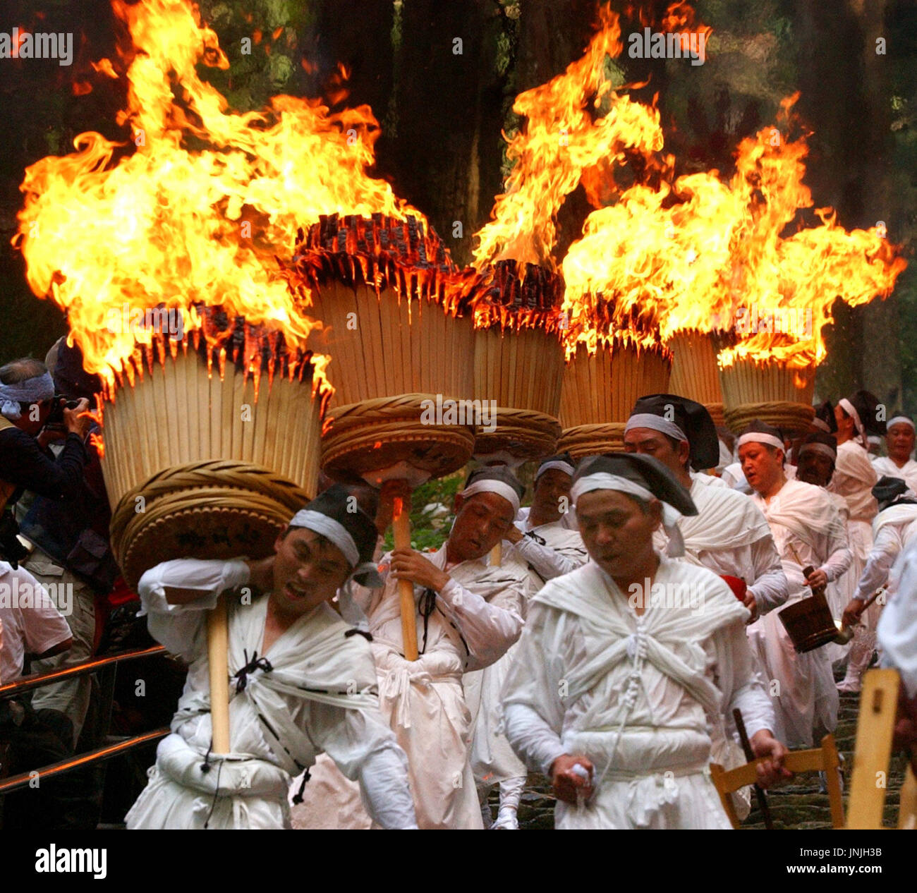 NACHIKATSUURA, Japan - Young people carry huge burning torches at the ...