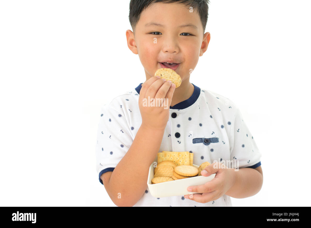 Cute little boy holding cookie isolated on white background Stock Photo ...