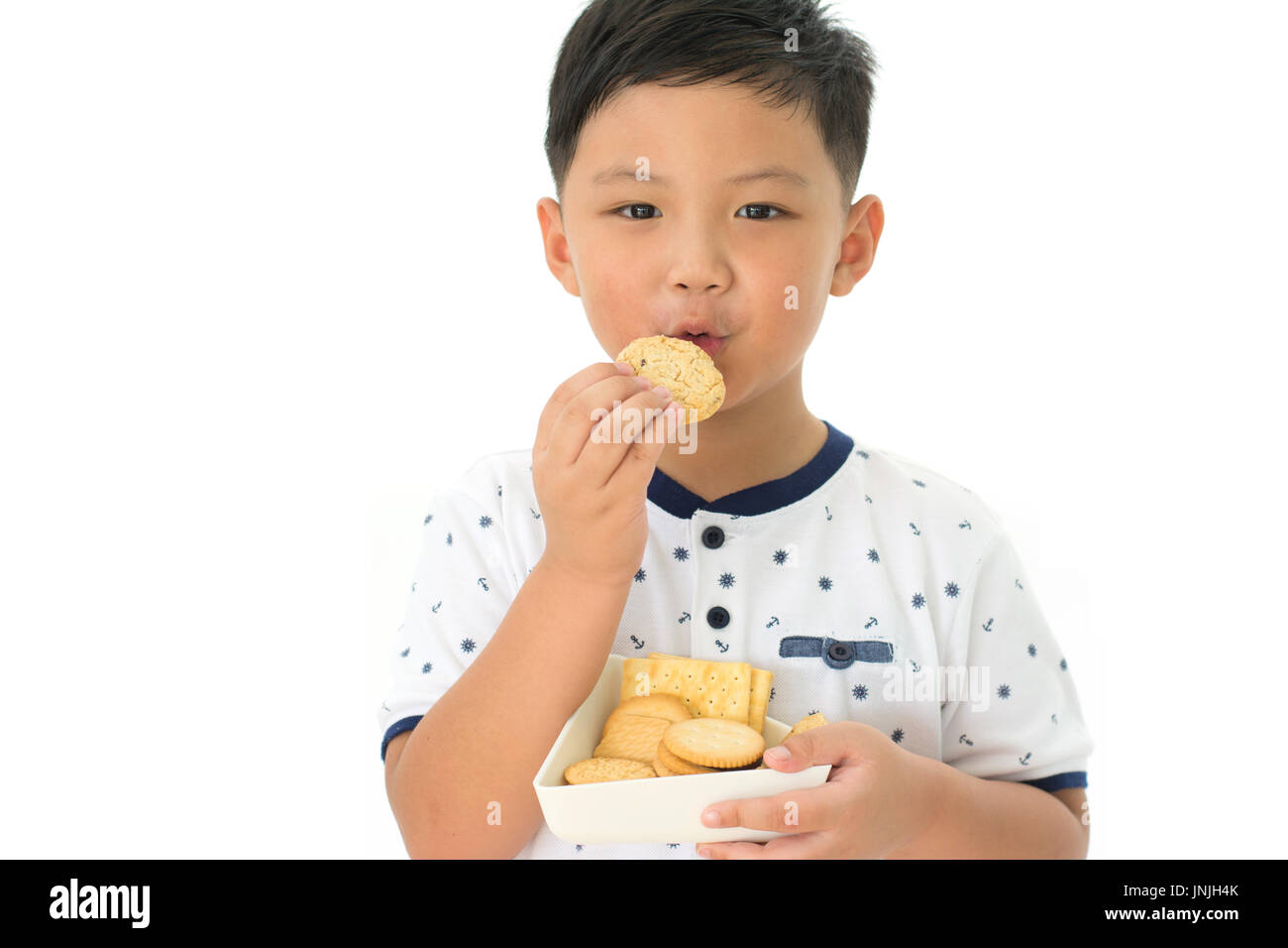 Cute little boy holding cookie isolated on white background Stock Photo ...