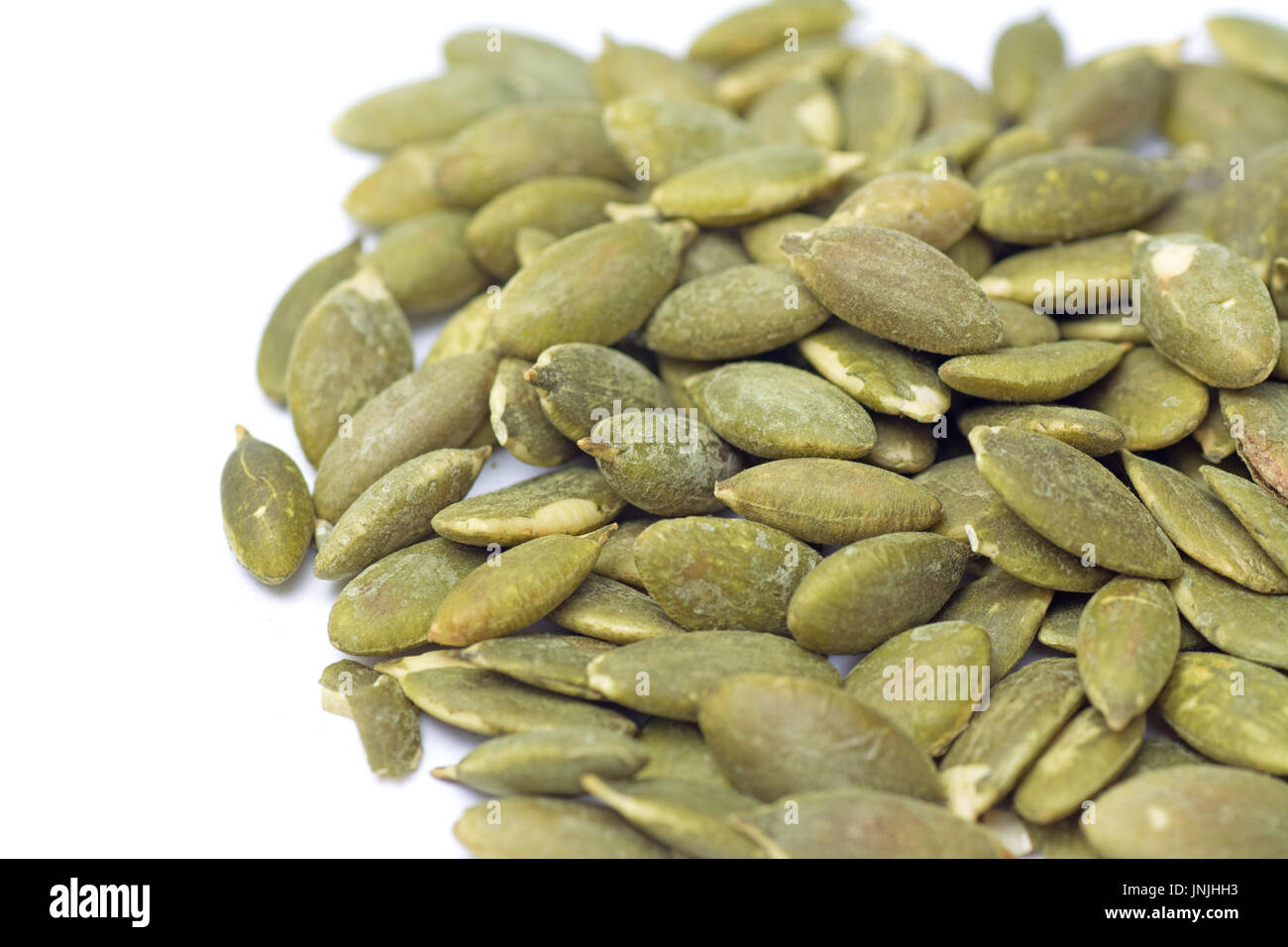 Roasted pumpkin kernels isolated on white background Stock Photo - Alamy