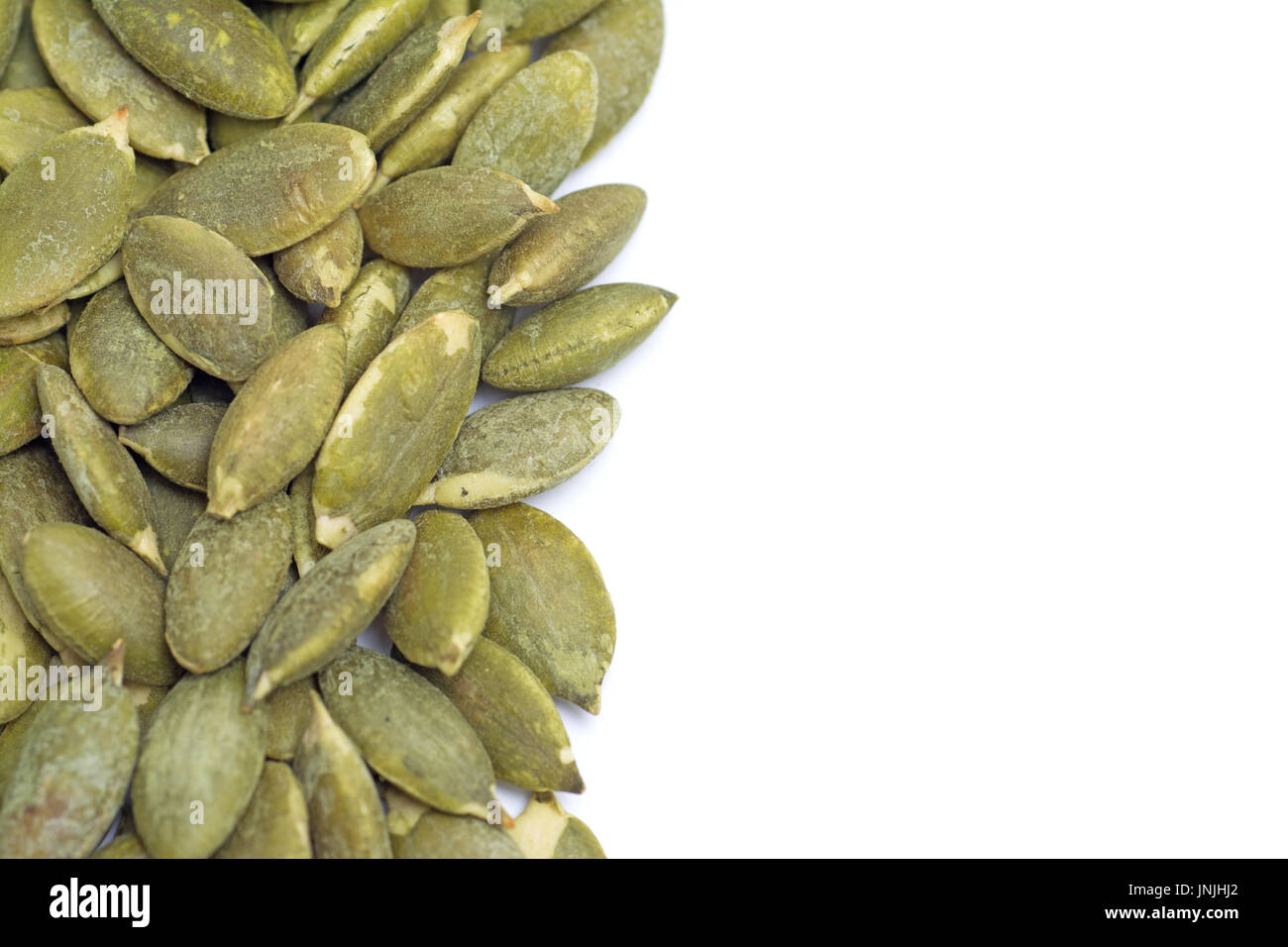 Roasted pumpkin kernels isolated on white background Stock Photo - Alamy